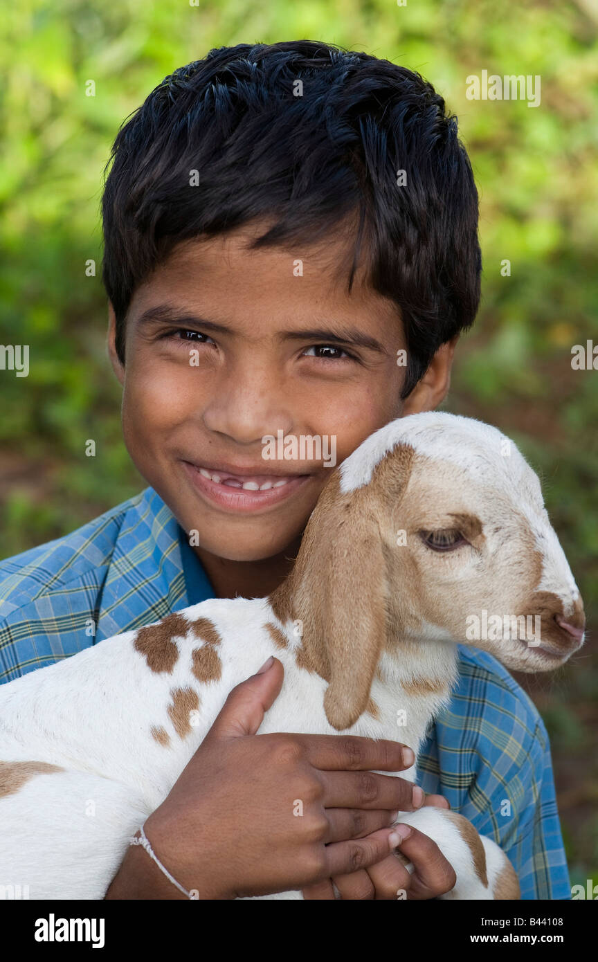 Indian boy holding a young kid goat. Andhra Pradesh, India Stock Photo ...
