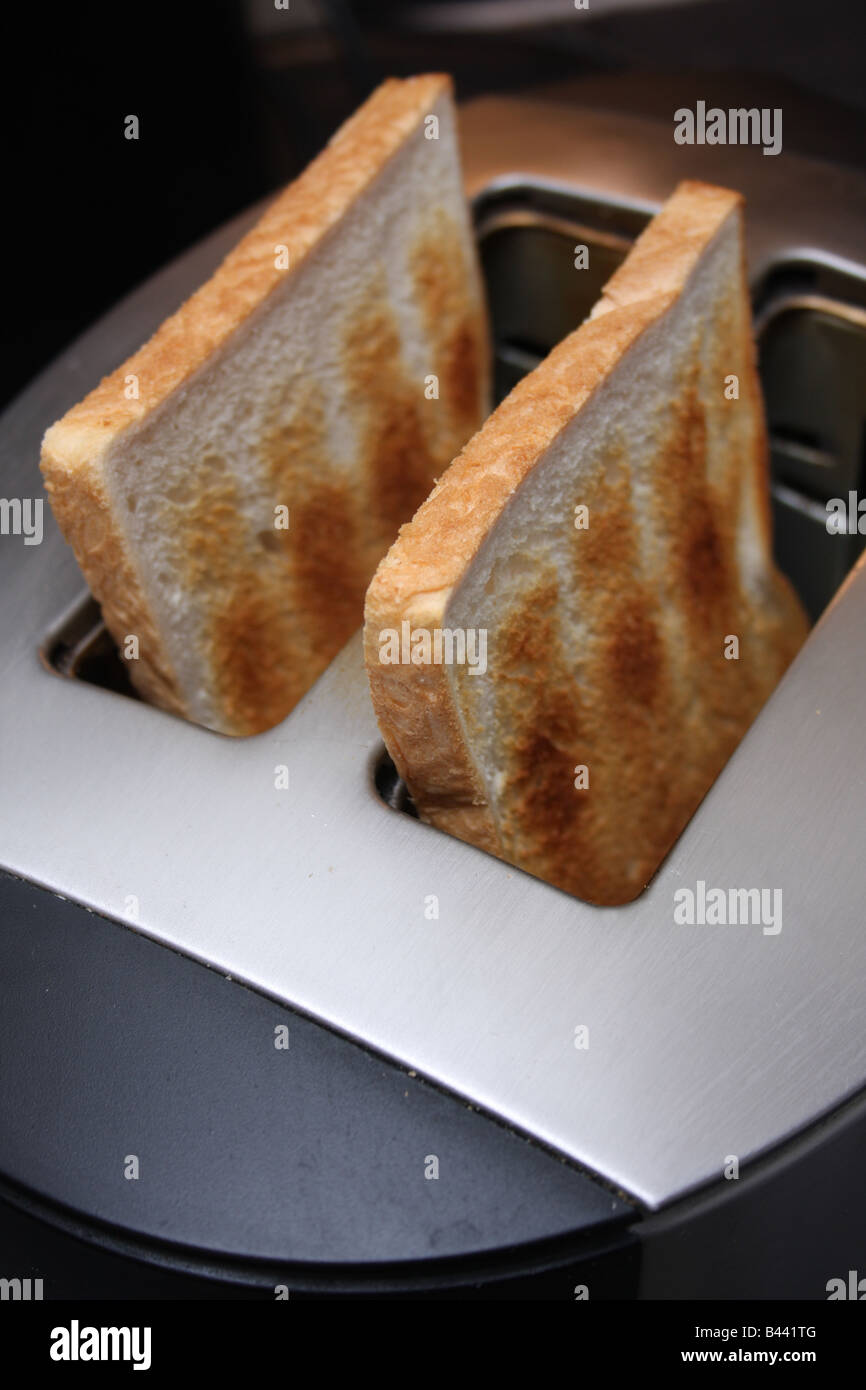 Two freshly sliced pieces of toast in a toaster Stock Photo - Alamy