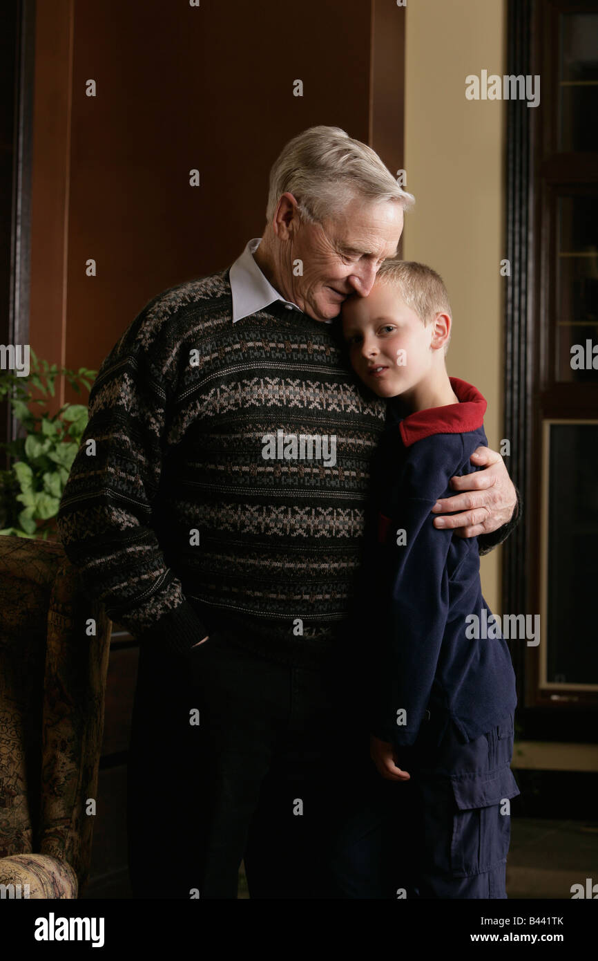 Grandfather hugging grandson Stock Photo - Alamy