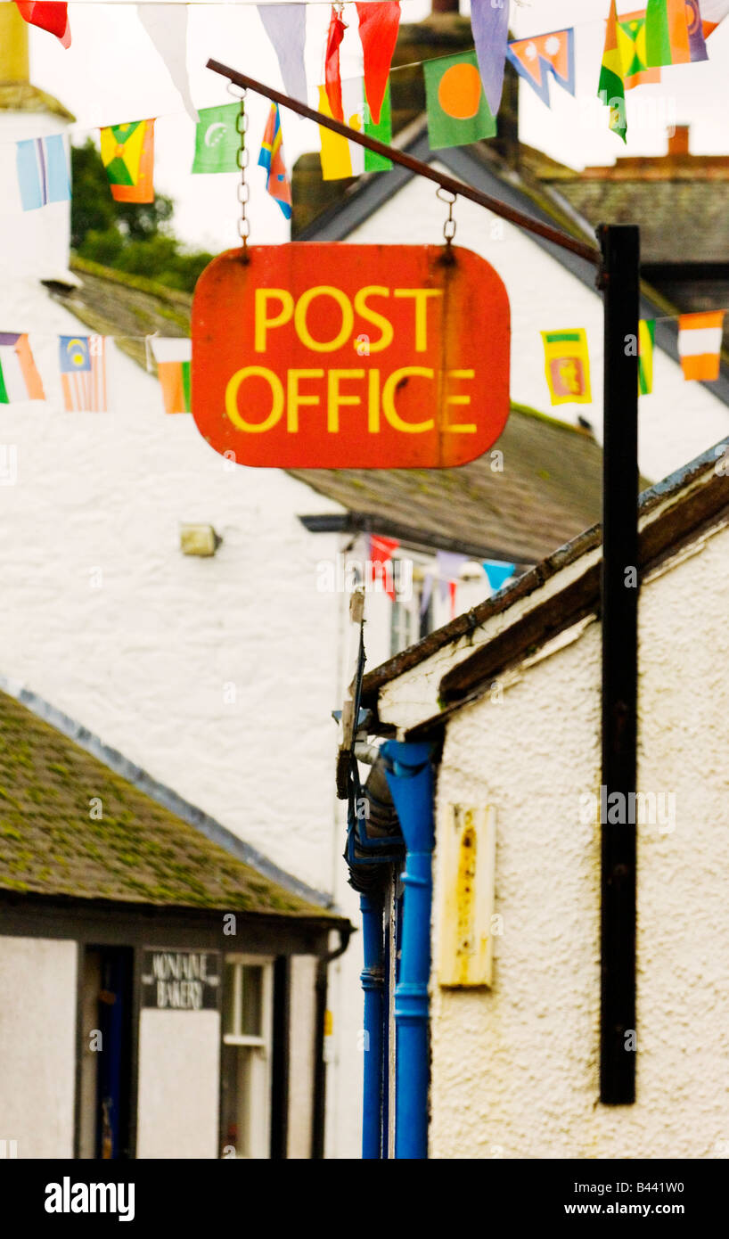 A British Post Office sign hangs outside a rural sub Post Office ...