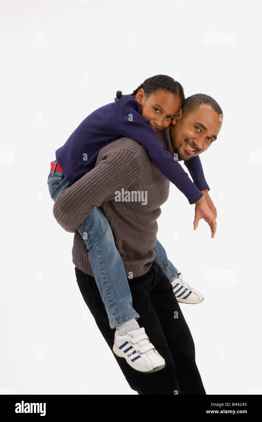 Dad giving daughter piggy back ride Stock Photo - Alamy