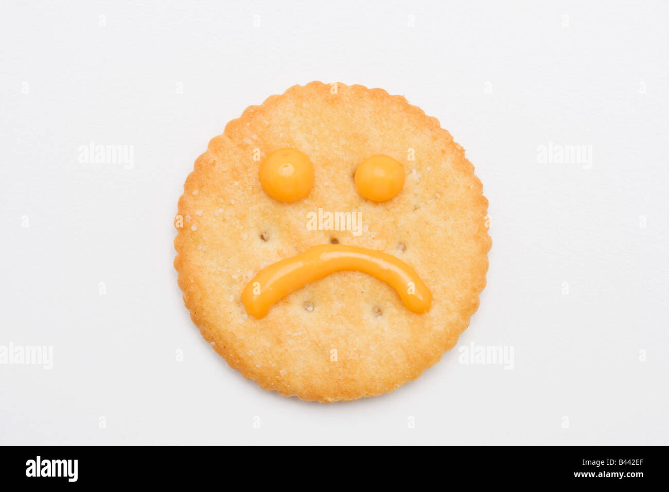 Sad face cracker Stock Photo - Alamy