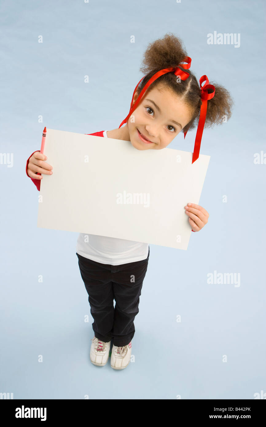 Girl holding up a book Stock Photo - Alamy