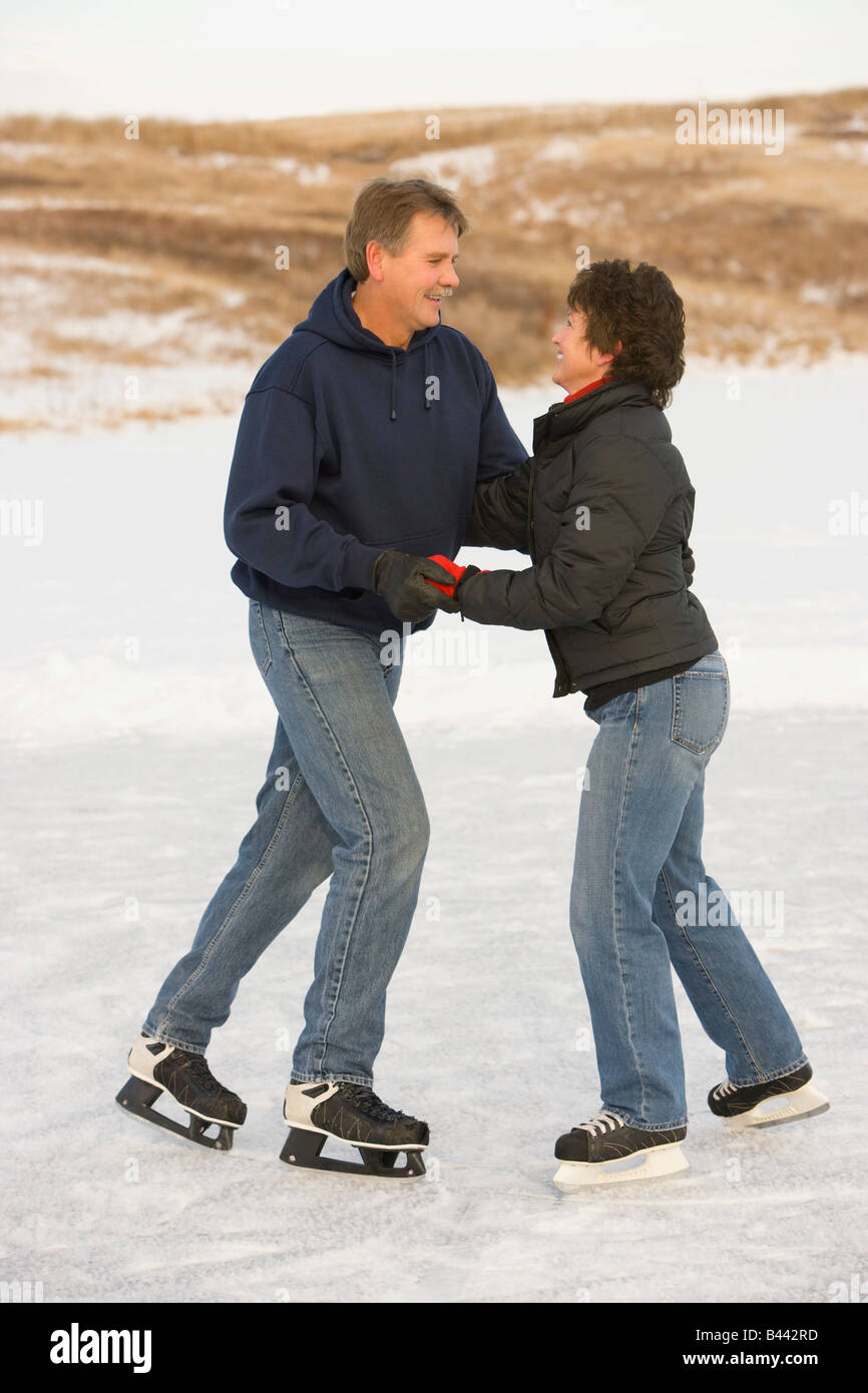 Couple ice skating together Stock Photo - Alamy