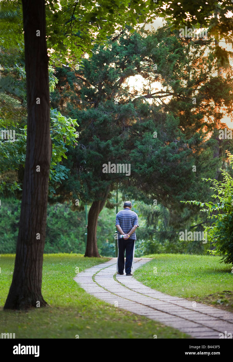 An old man walking alone at sunset at Niska Banya a health spa south of ...