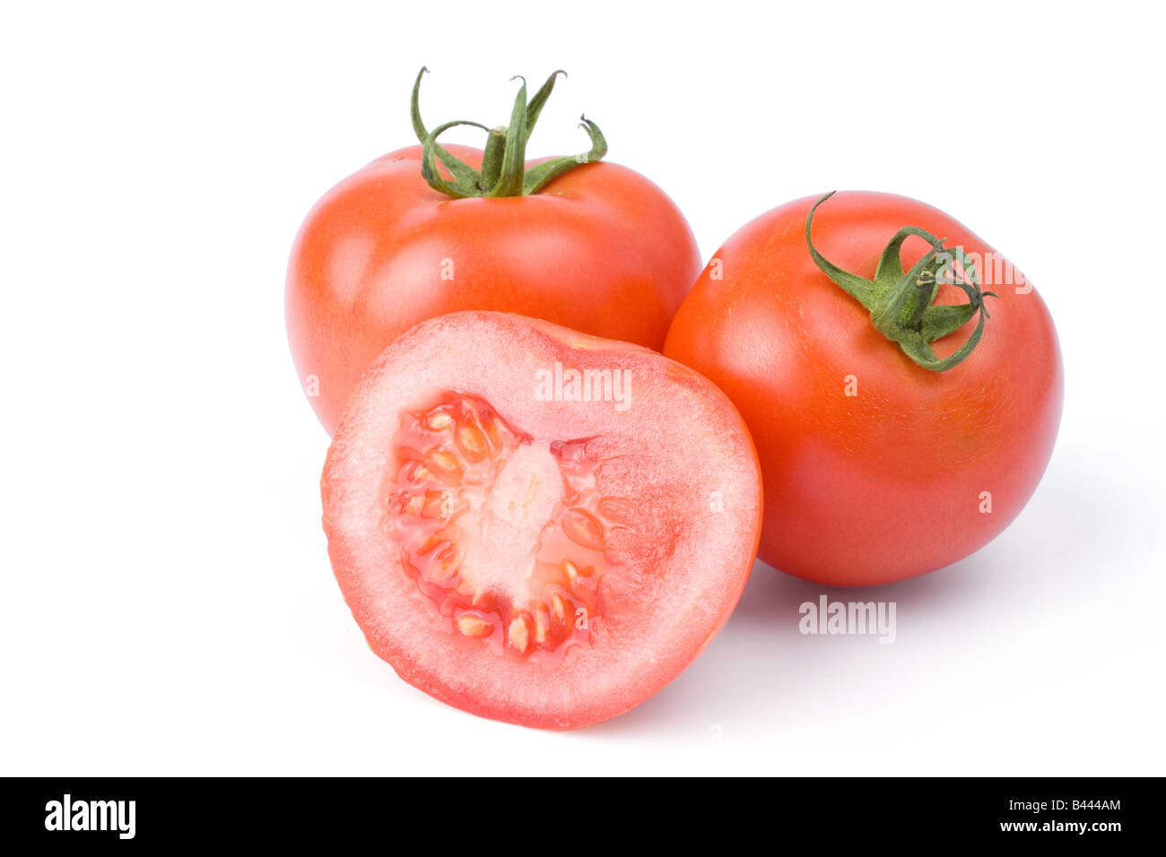 Ripe tomatoes isolated on a white background with one cut in half Stock ...