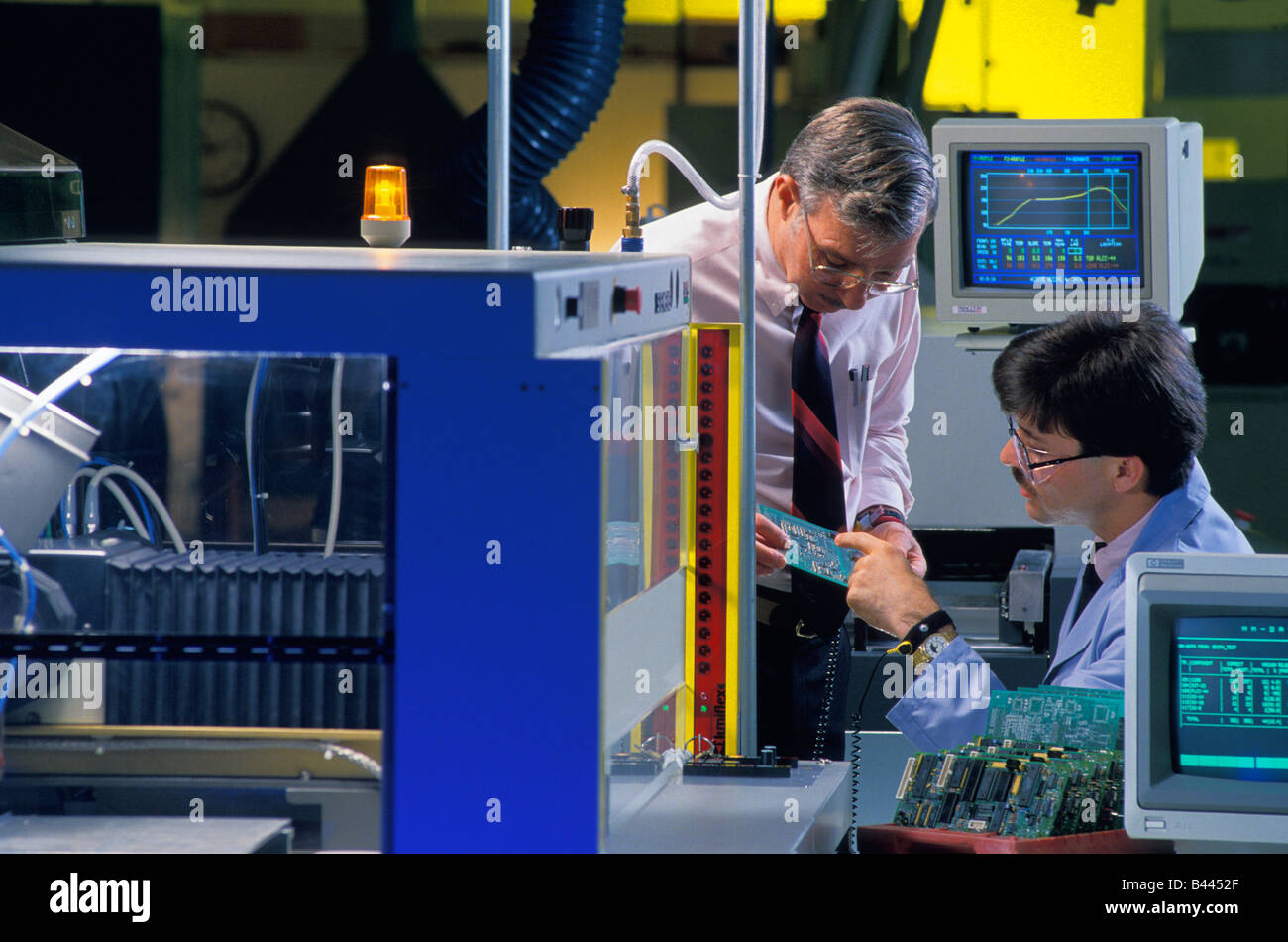 Quality control inspection of electronic circuit board by supervisor ...