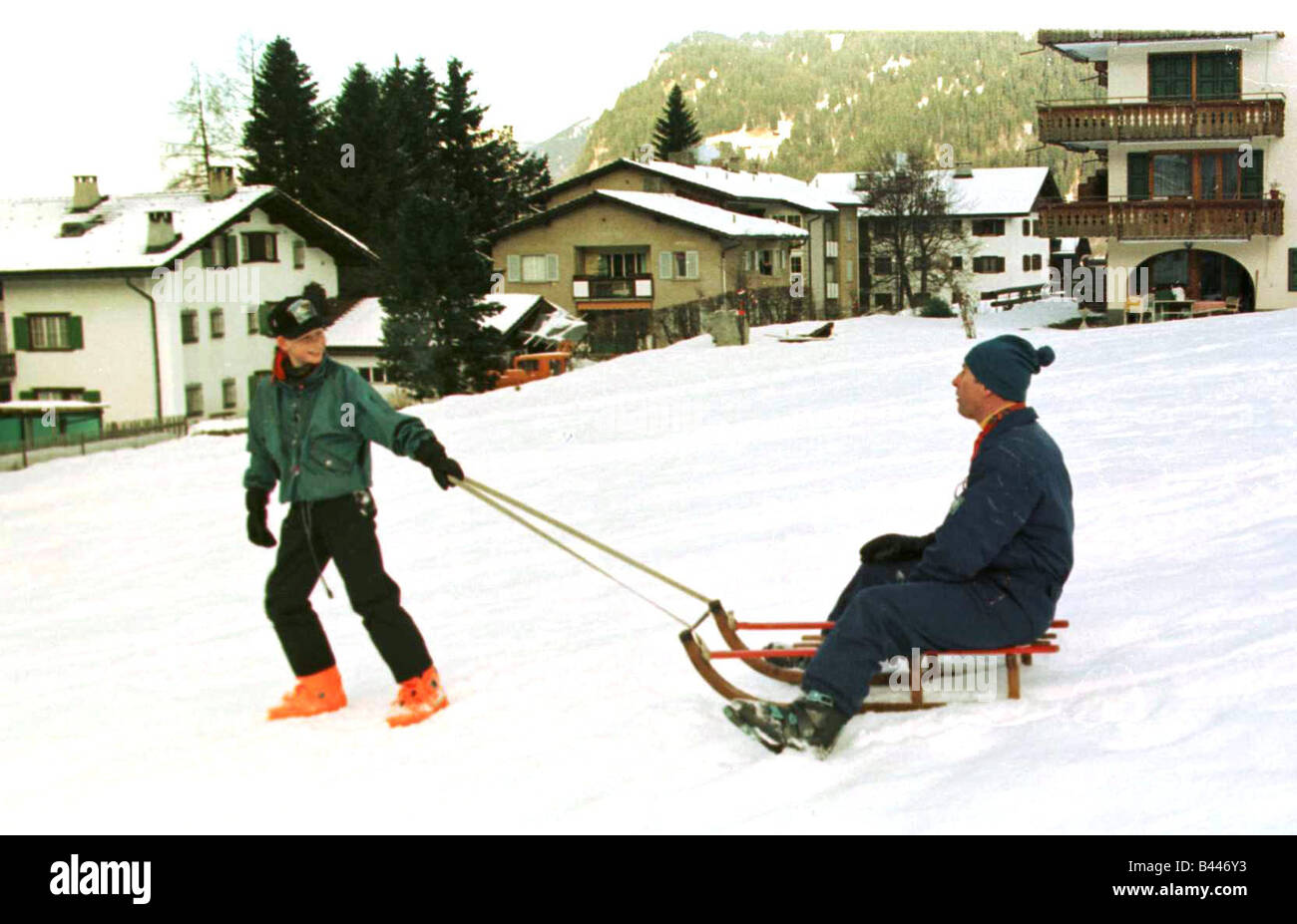 Prince Charles is pulled on a sledge by Prince Harry while on holiday ...