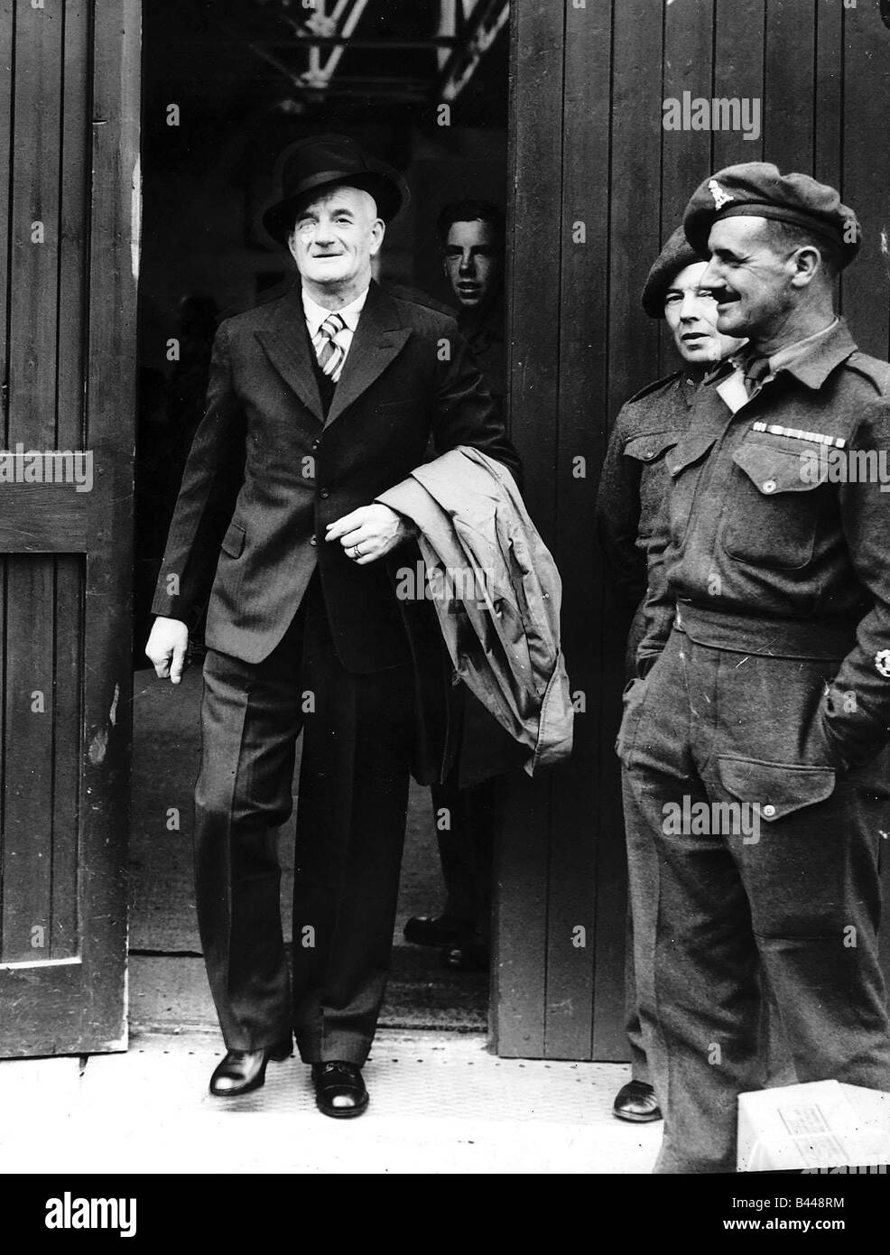 World War Two Discharged soldier leaving clothes store wearing his ...