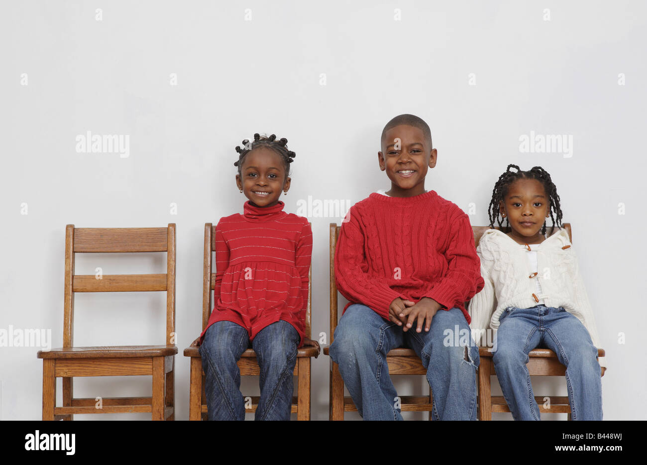 African siblings sitting in chairs Stock Photo - Alamy