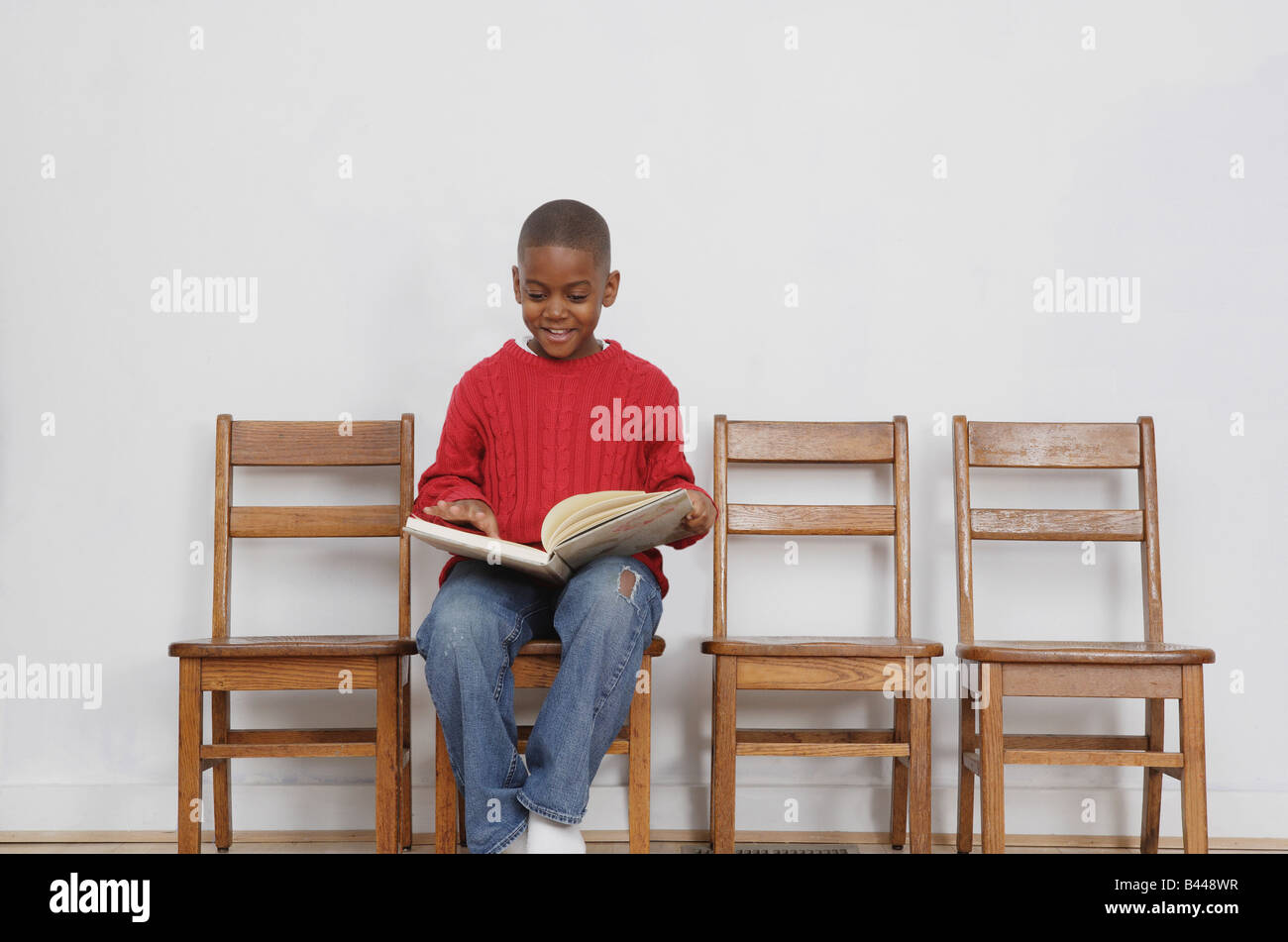 African boy reading book Stock Photo - Alamy