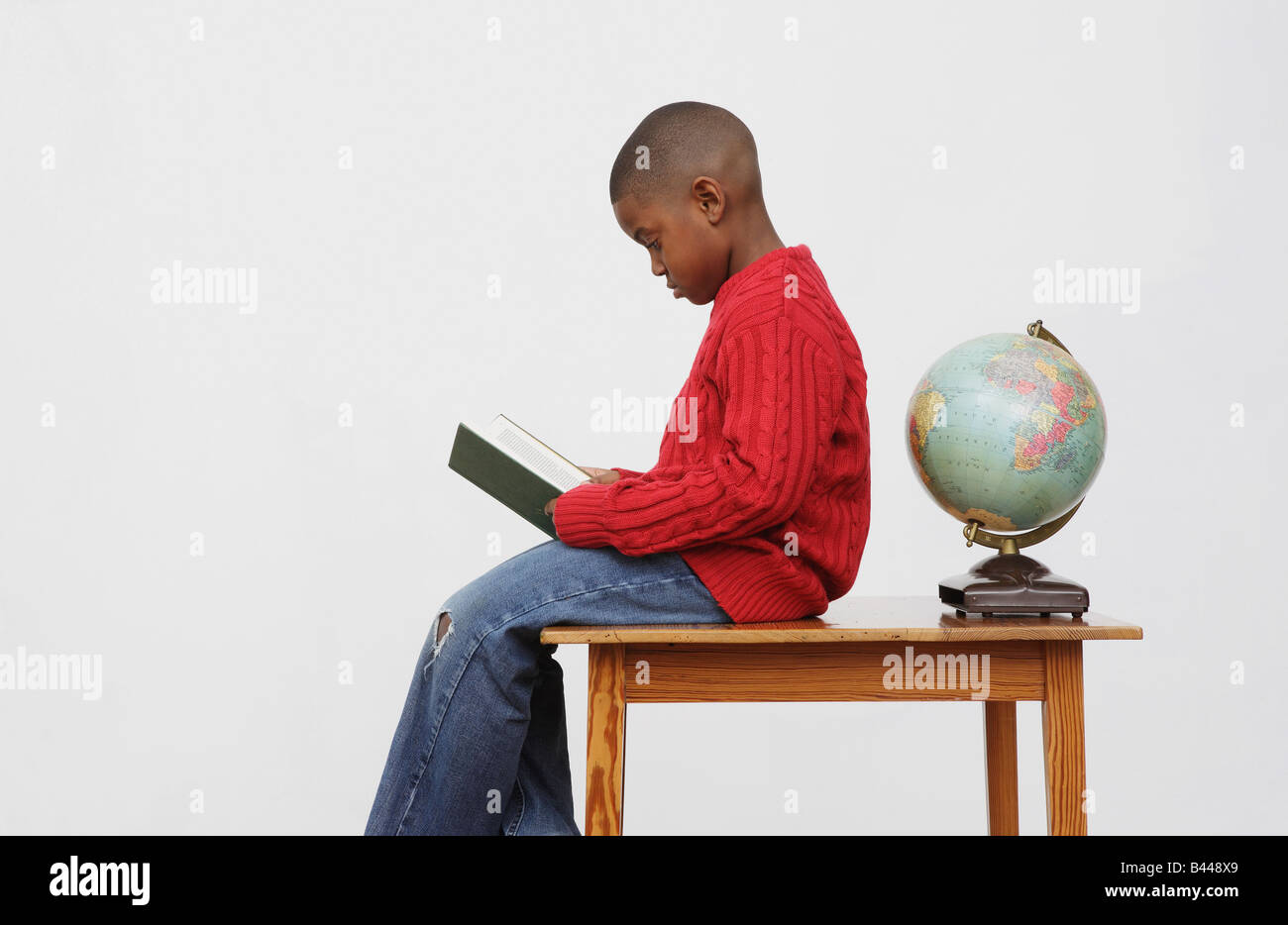 African boy reading book Stock Photo - Alamy