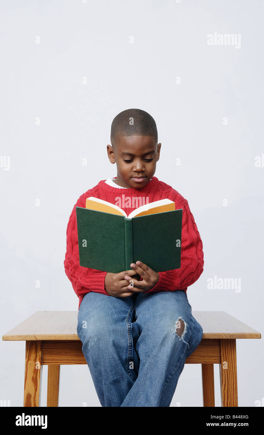 African boy reading book Stock Photo - Alamy