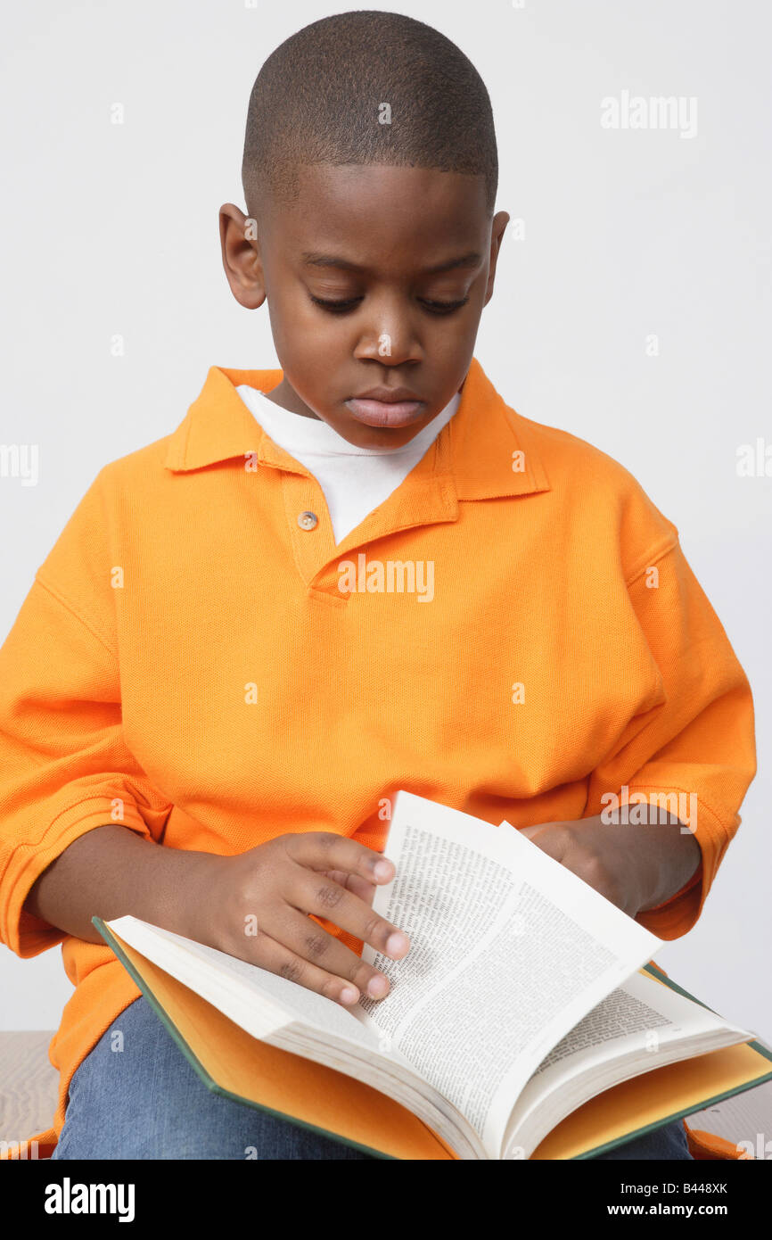 African boy reading book Stock Photo - Alamy
