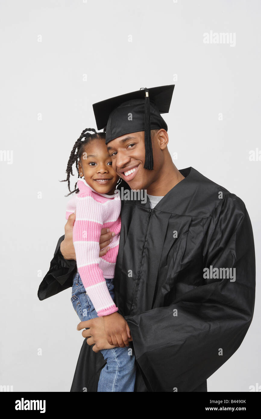 African male graduate holding daughter Stock Photo - Alamy
