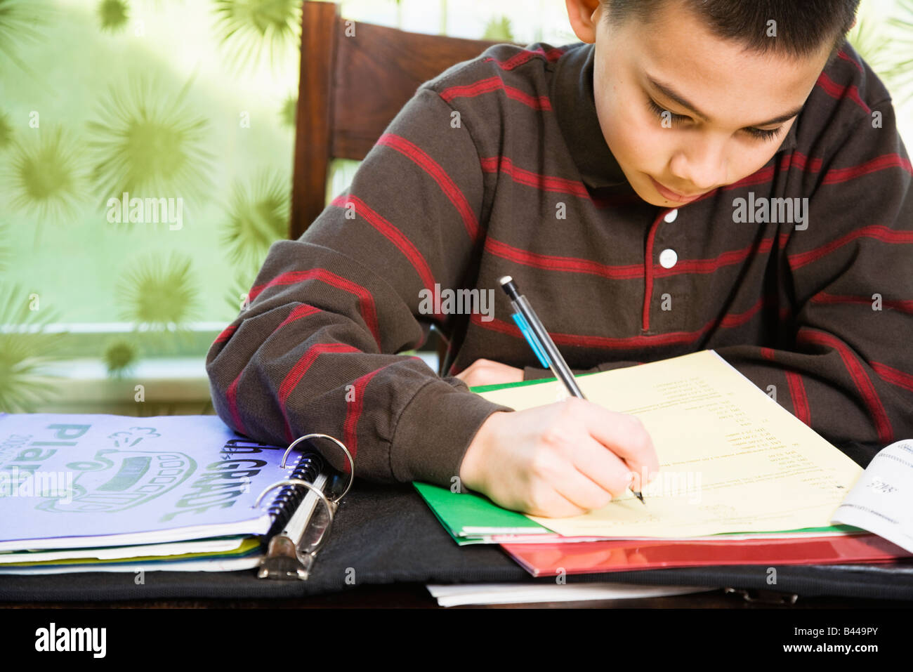 Asian boy doing homework Stock Photo - Alamy