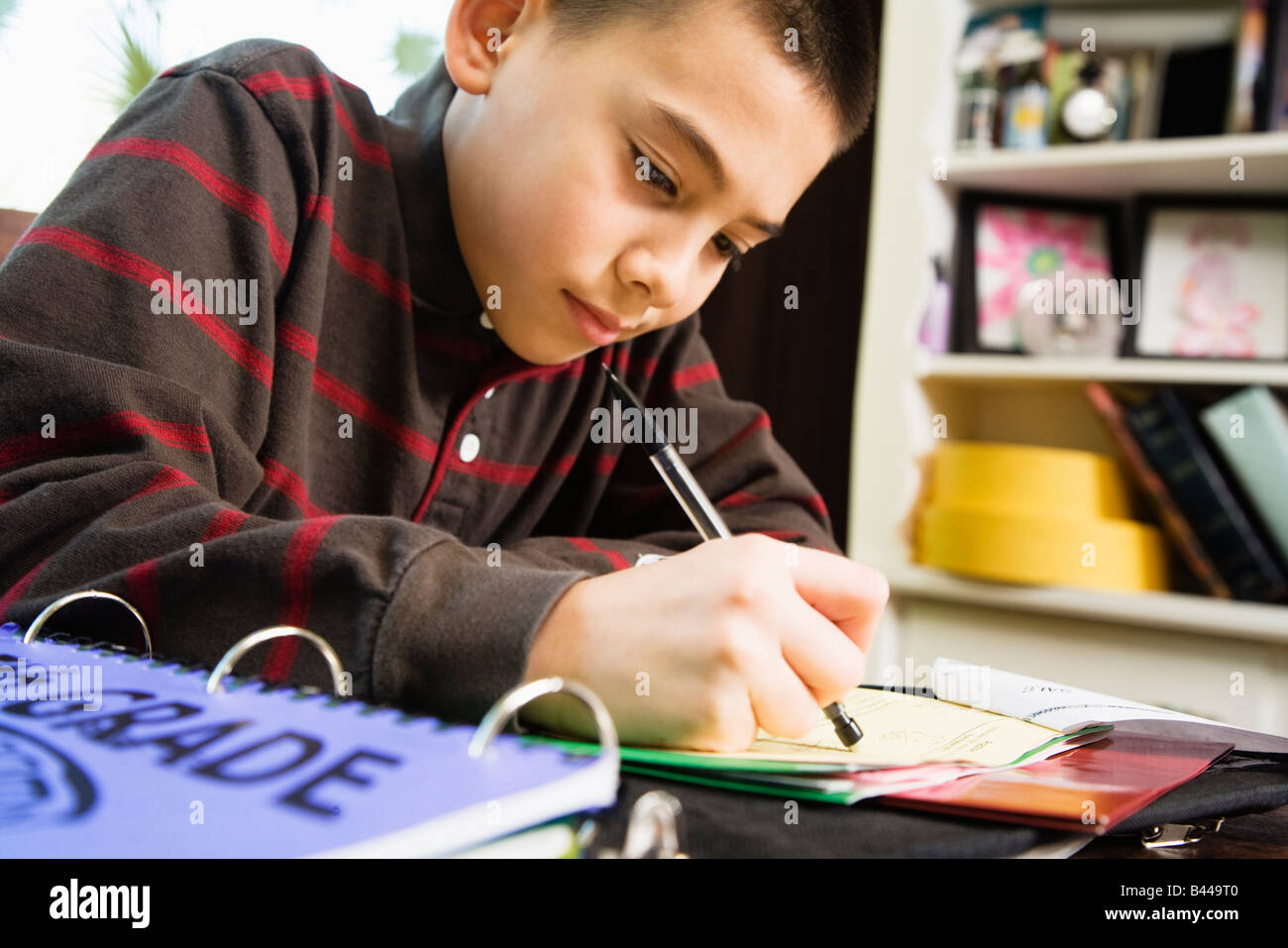 Asian boy doing homework Stock Photo - Alamy