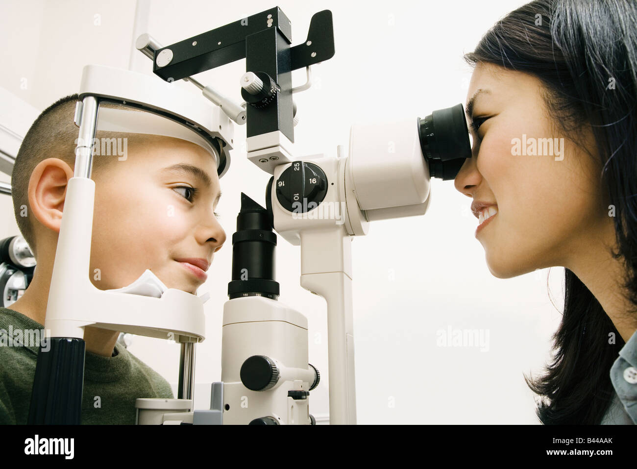 Asian female optometrist examining patient Stock Photo - Alamy