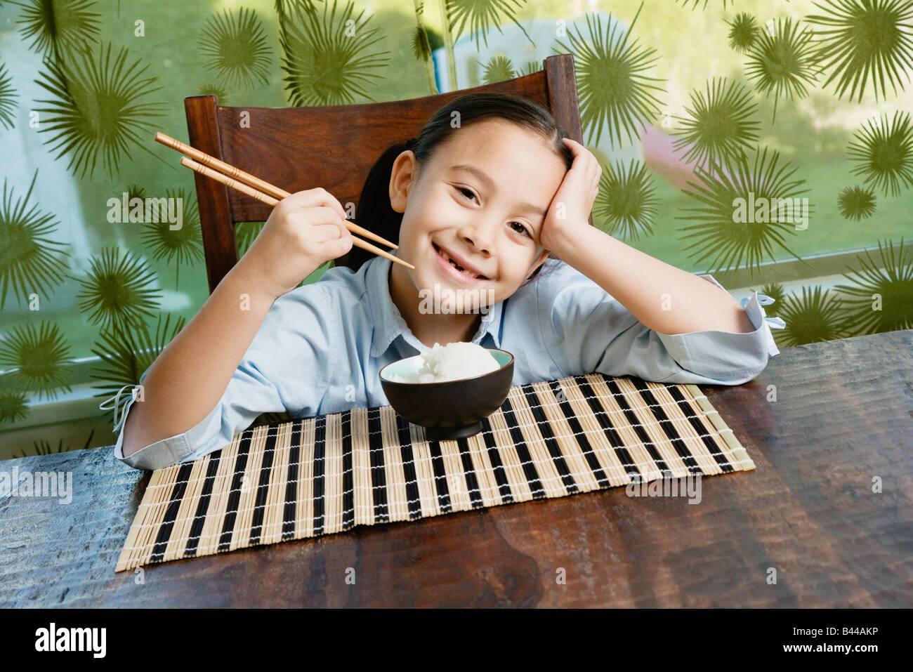 Asian girl eating bowl of rice Stock Photo - Alamy