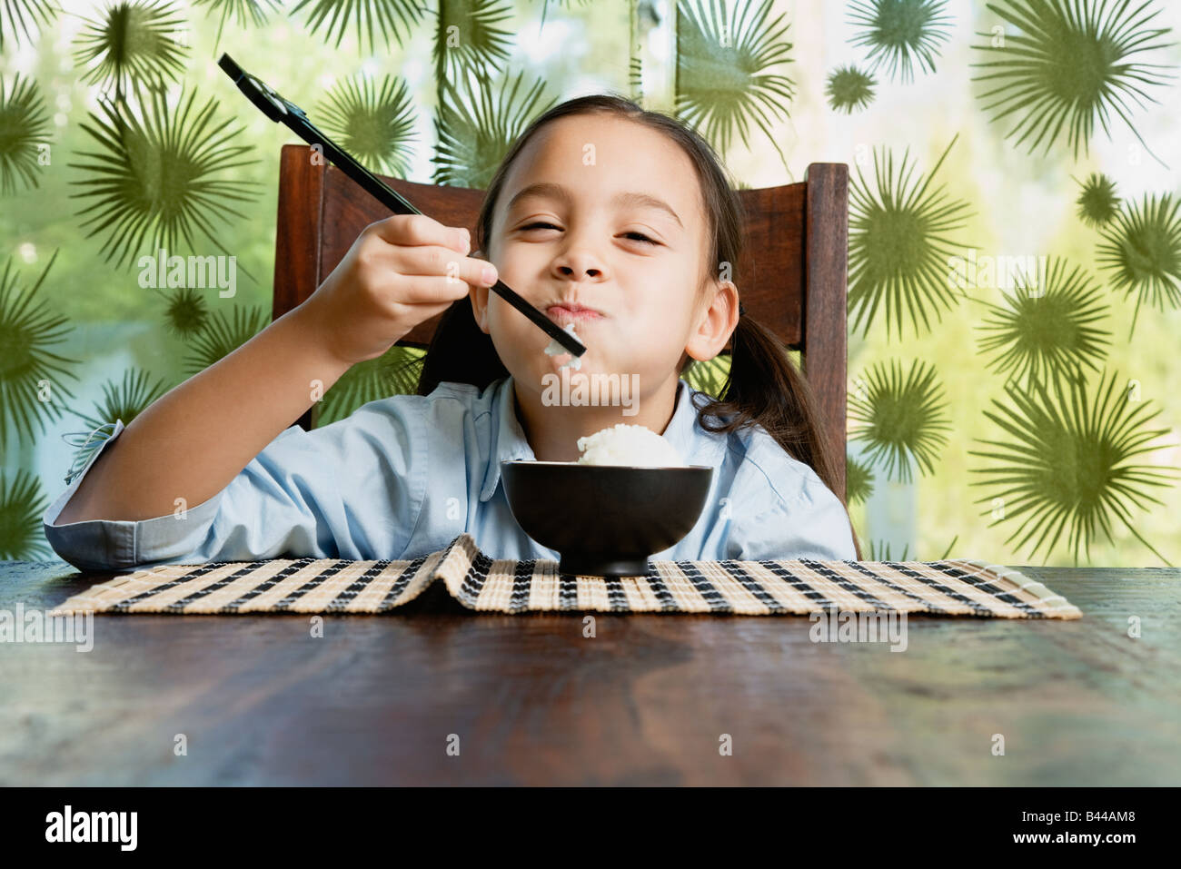 Asian girl eating bowl of rice Stock Photo - Alamy