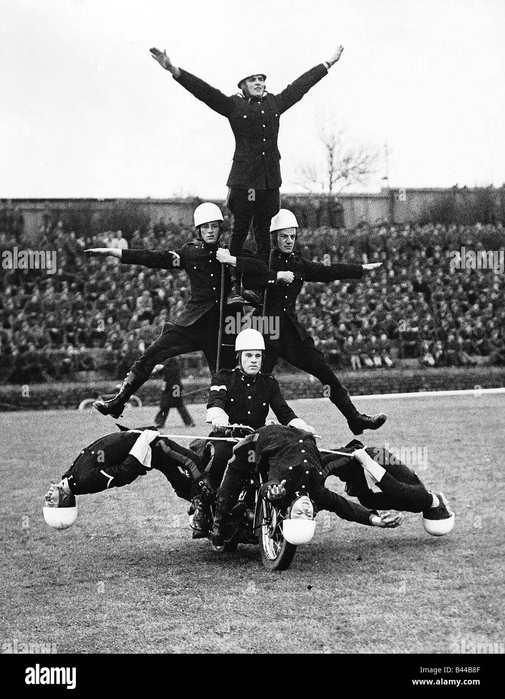 Royal Signal Corps Motor Cycles display team riding around in an arena ...