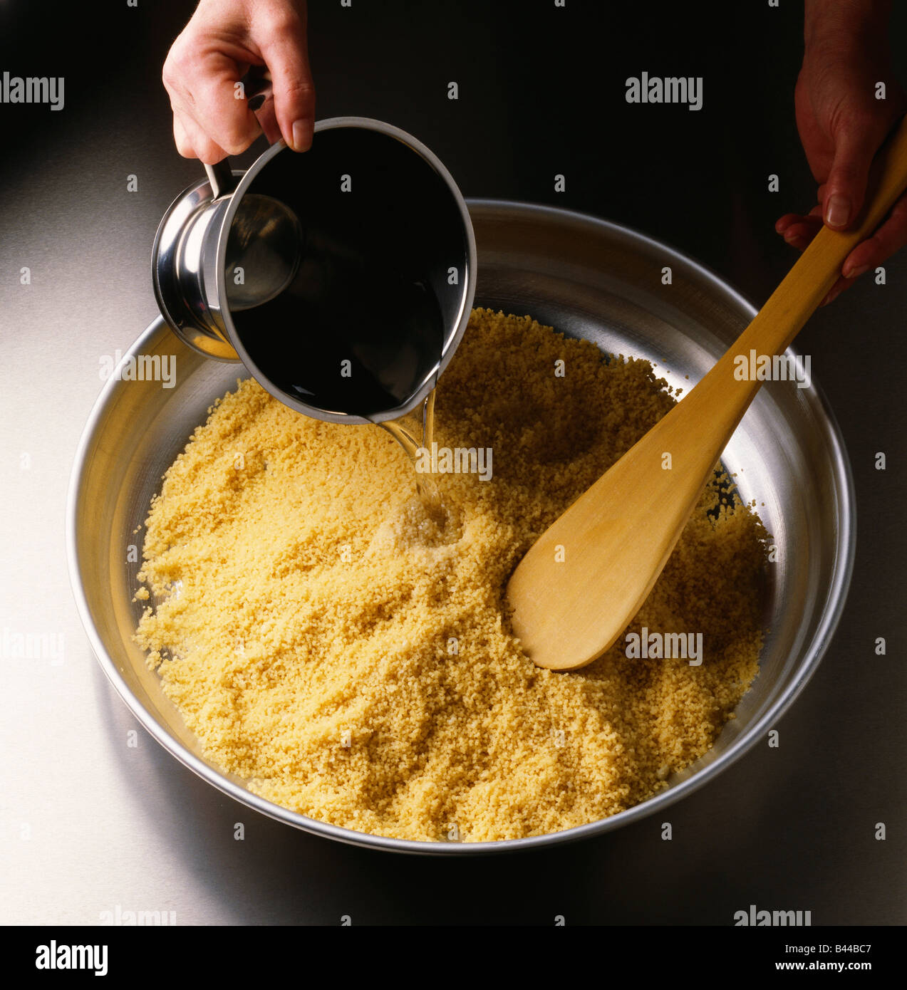 Adding water to the semolina Stock Photo - Alamy