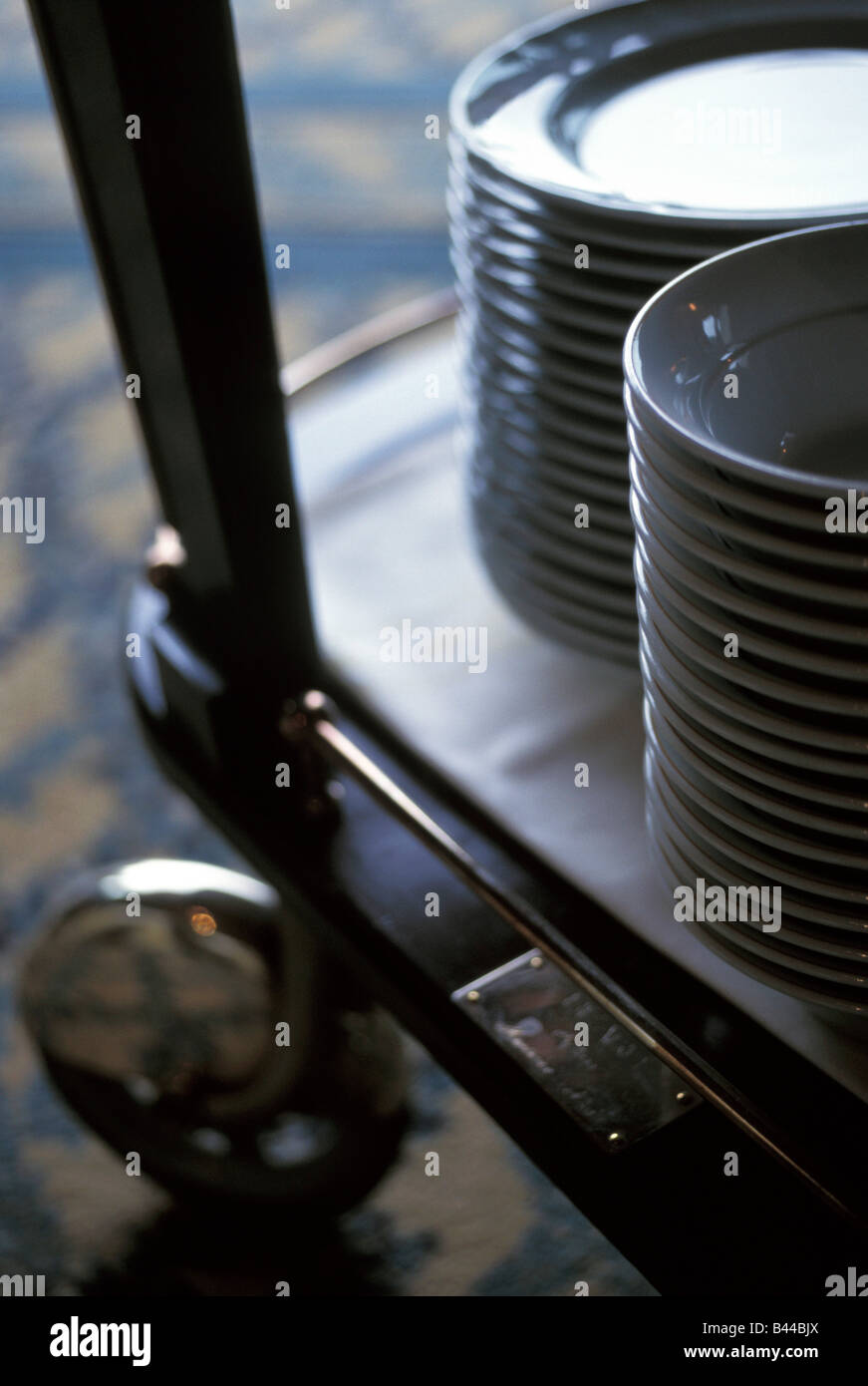 Stack of plates on a trolley Stock Photo - Alamy