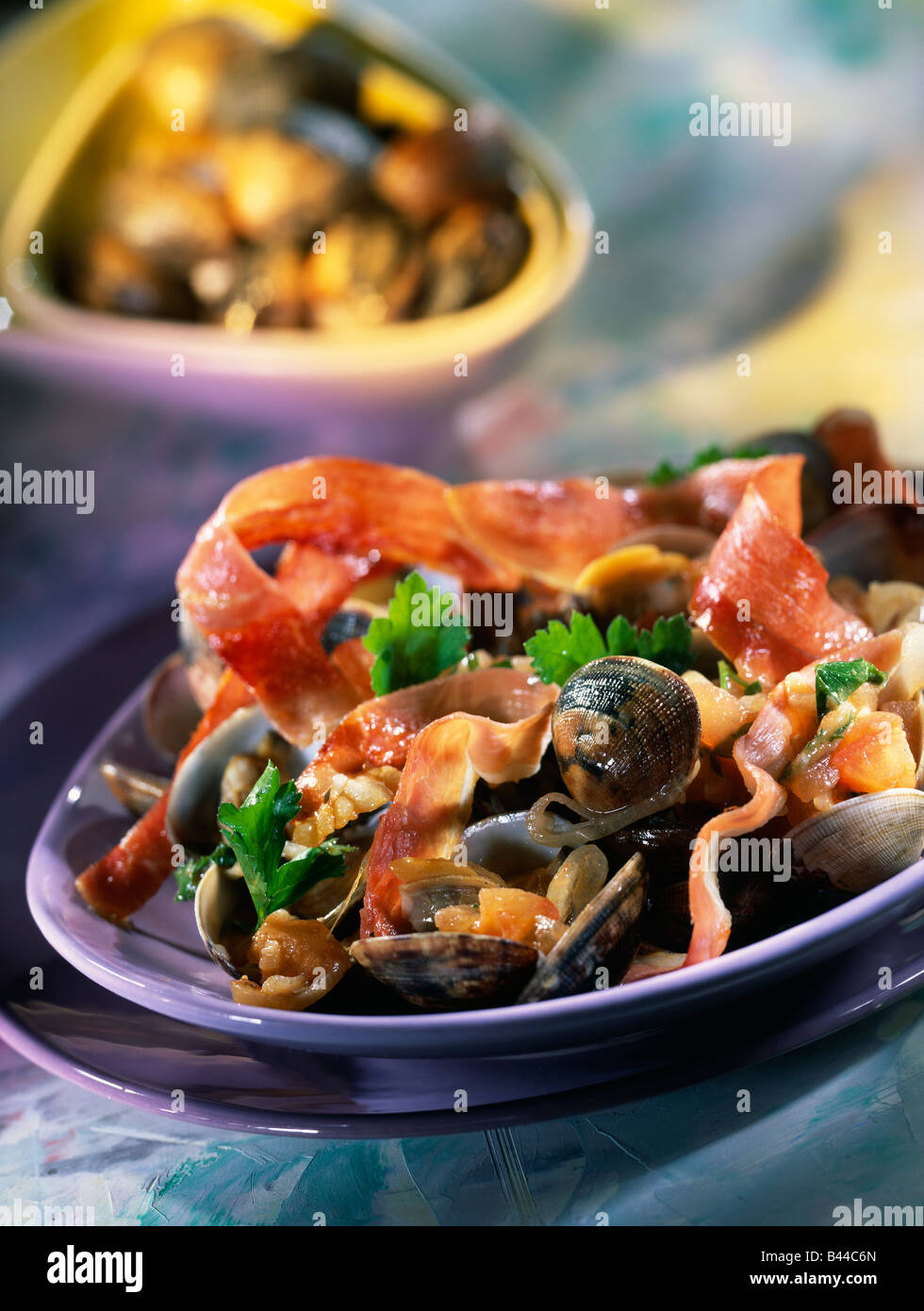 Carpet-shell clams with raw ham Stock Photo - Alamy