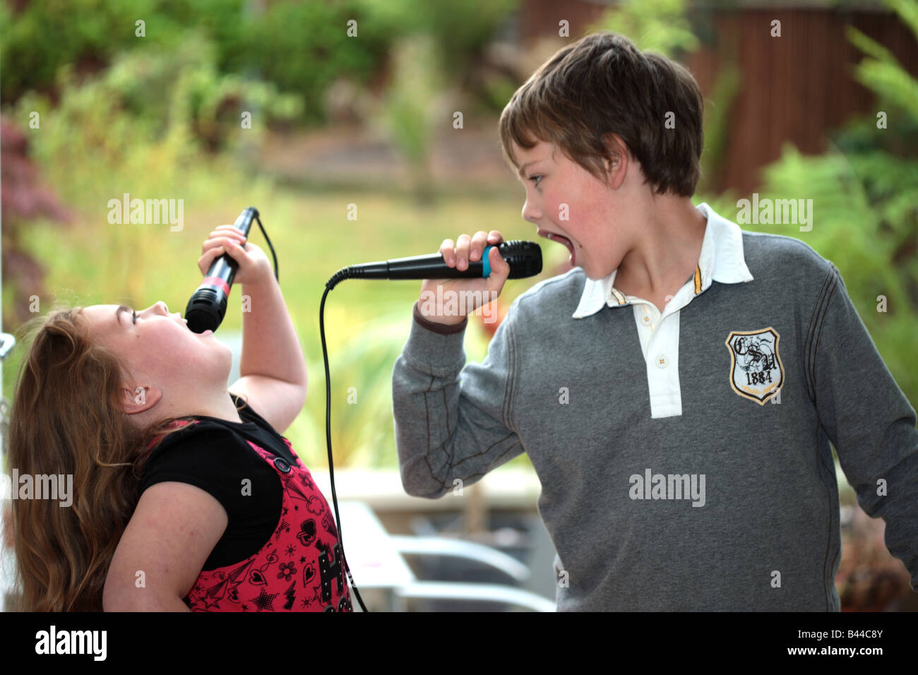 Boy and Girl Singing Model Released Stock Photo - Alamy