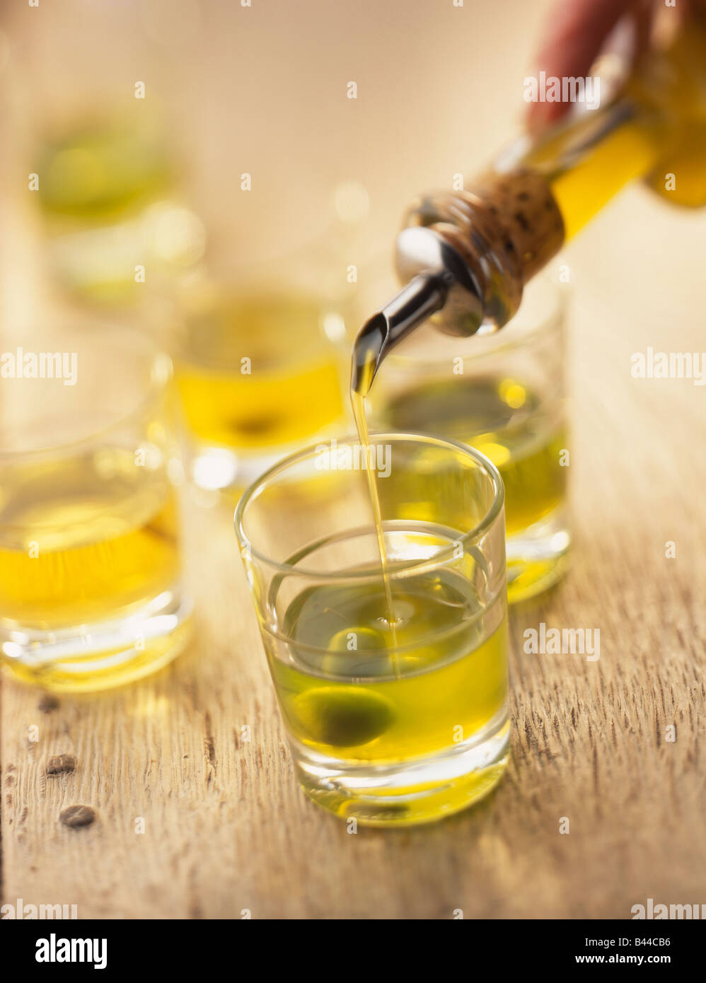 Pouring olive oil into a glass Stock Photo - Alamy