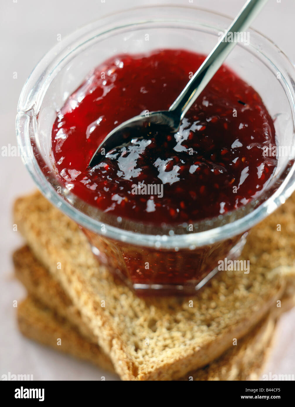 Pot of raspberry jam and toast Stock Photo - Alamy
