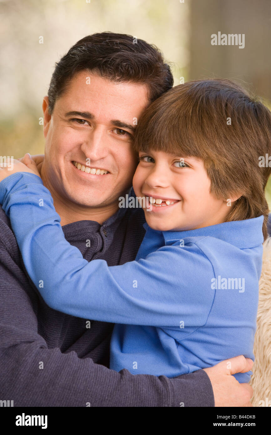 Hispanic father and son hugging Stock Photo - Alamy