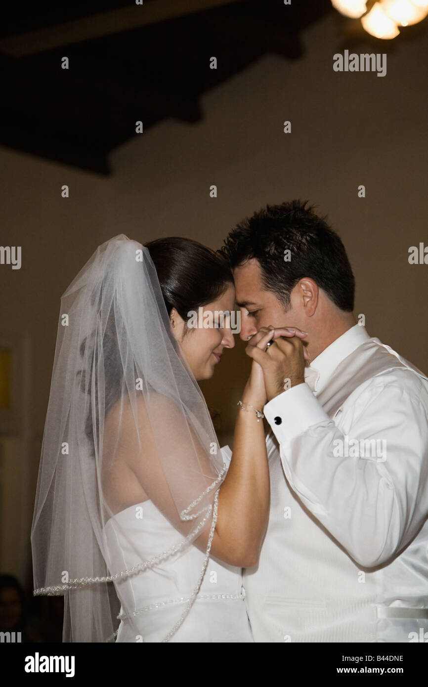 Hispanic bride and groom dancing Stock Photo - Alamy