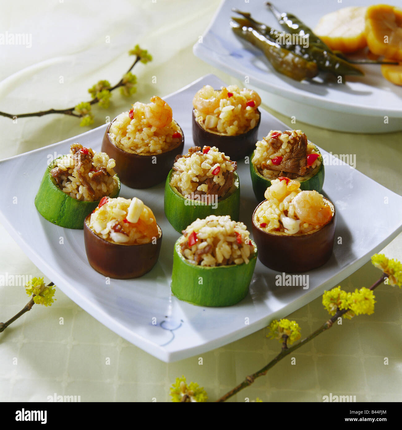 Thick round slices of eggplant and courgette stuffed with fried rice ...