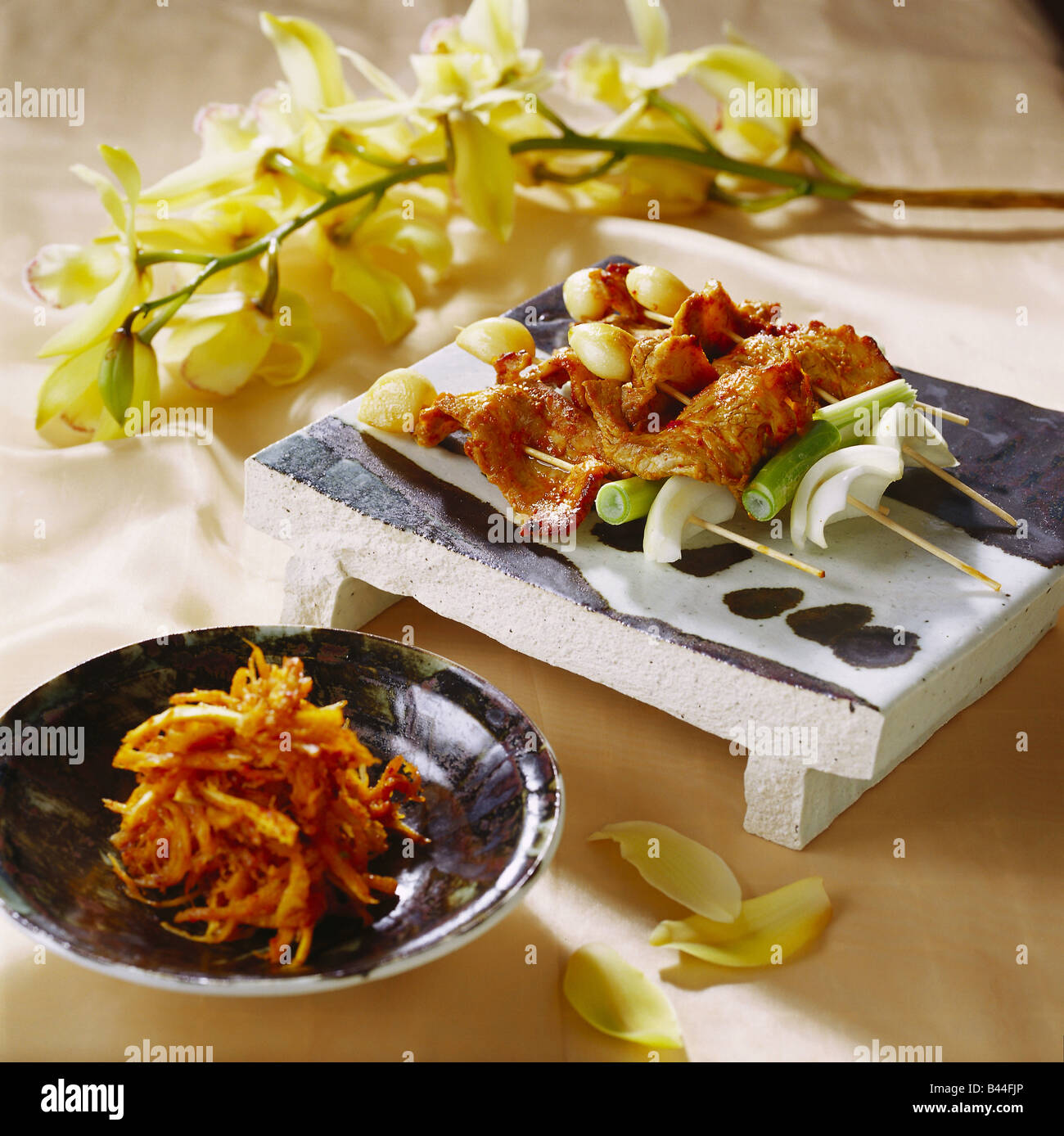 Spicy grilled pork brochettes and Deodeok Stock Photo - Alamy