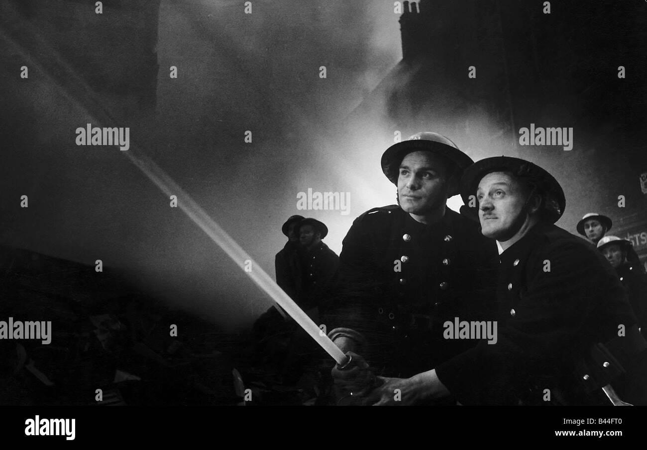 Firemen tackling fire after WW2 air raid on London 1940s Stock Photo ...