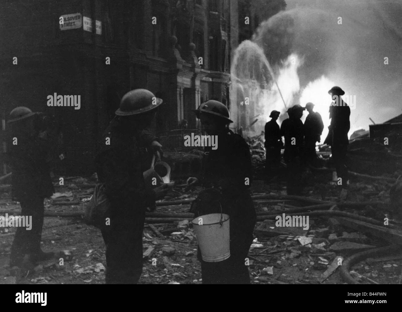 WW2 standing in street where fire is Stock Photo - Alamy