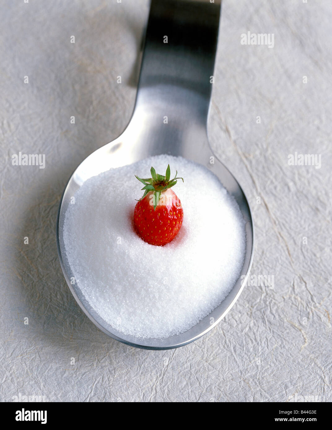 spoonful of sugar and strawberry Stock Photo - Alamy