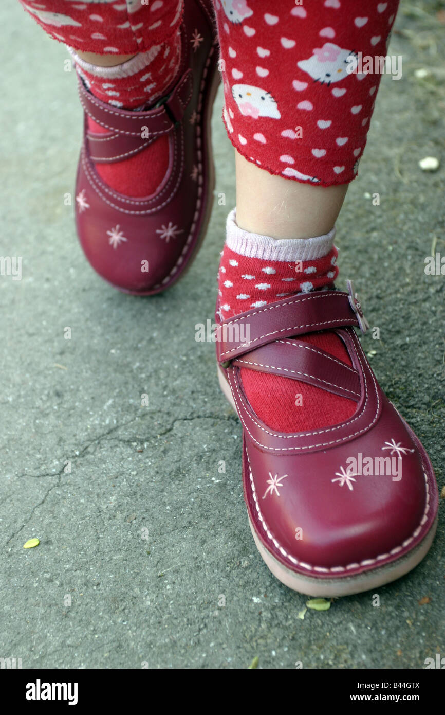 Young girl walking along the pavement Stock Photo - Alamy