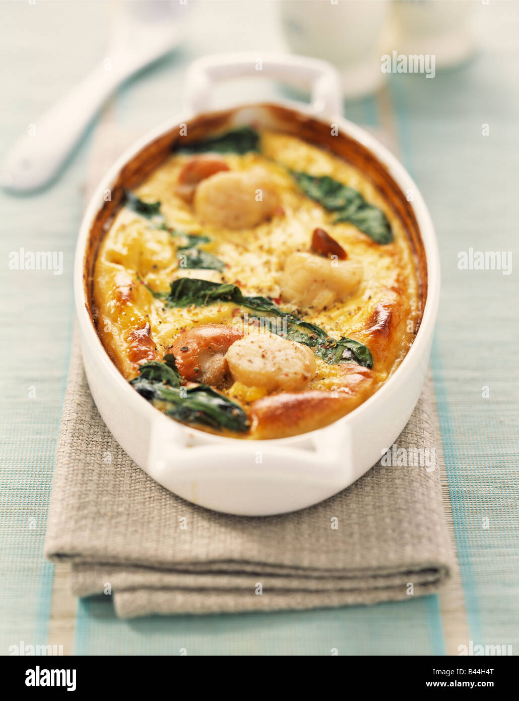 Scallop and spinach Clafoutis batter pudding Stock Photo - Alamy