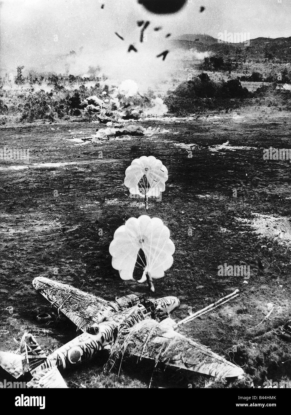 The US Air Force drop parafrag bombs on a Japanese airfield during WW2 ...