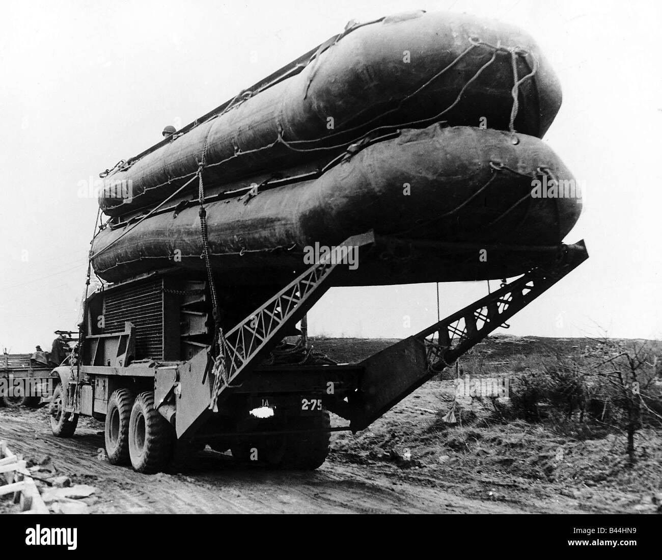 Engineer vehicles of 1st US Army carrying pontoons towards River Roer ...