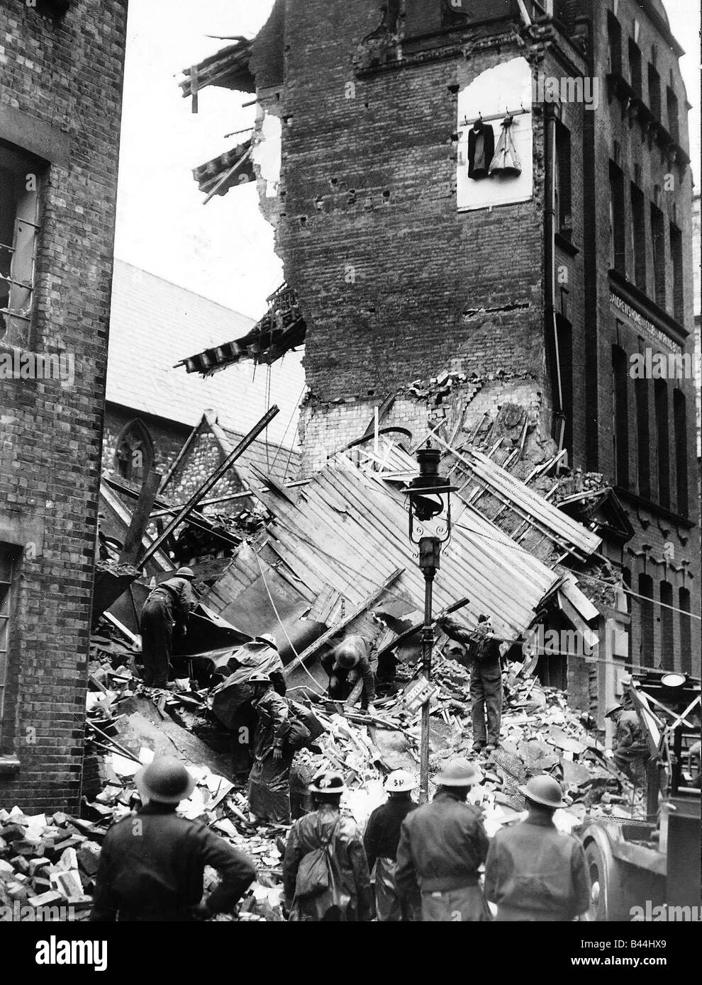 Rescue workers search the rubble after a London office block was hit ...