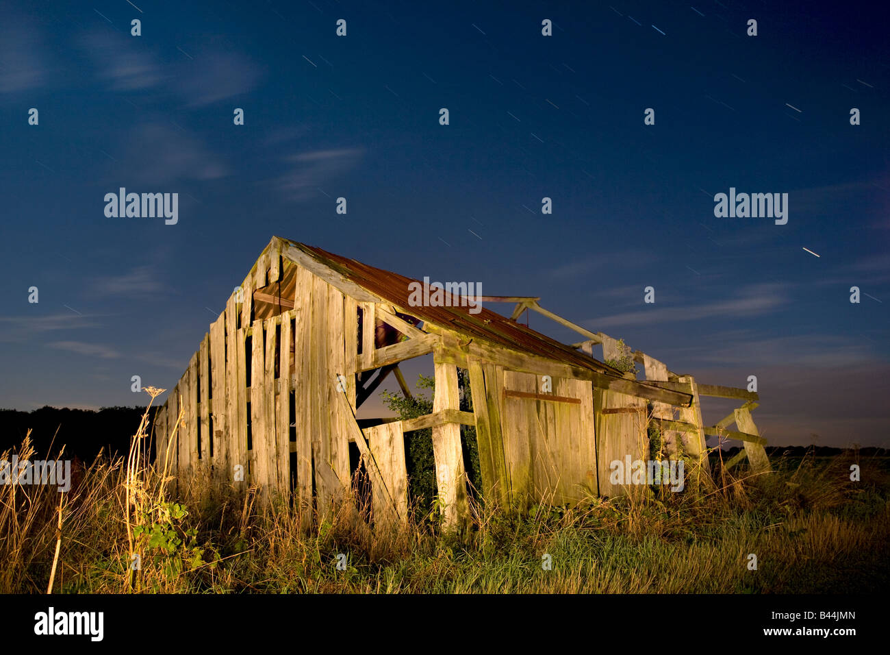 Old derelict wooden barn photographed at night during a long exposure ...