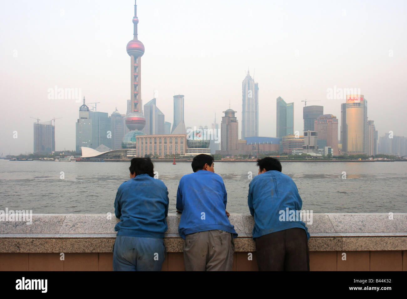 Three men looking at the cityscape of Pudong in Shanghai, China Stock ...