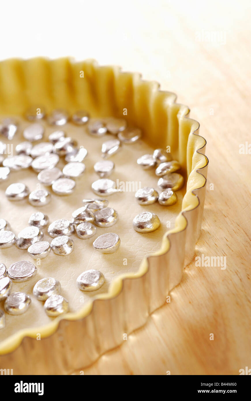 shortcrust pastry in mould filled with lead beans for cooking Stock ...