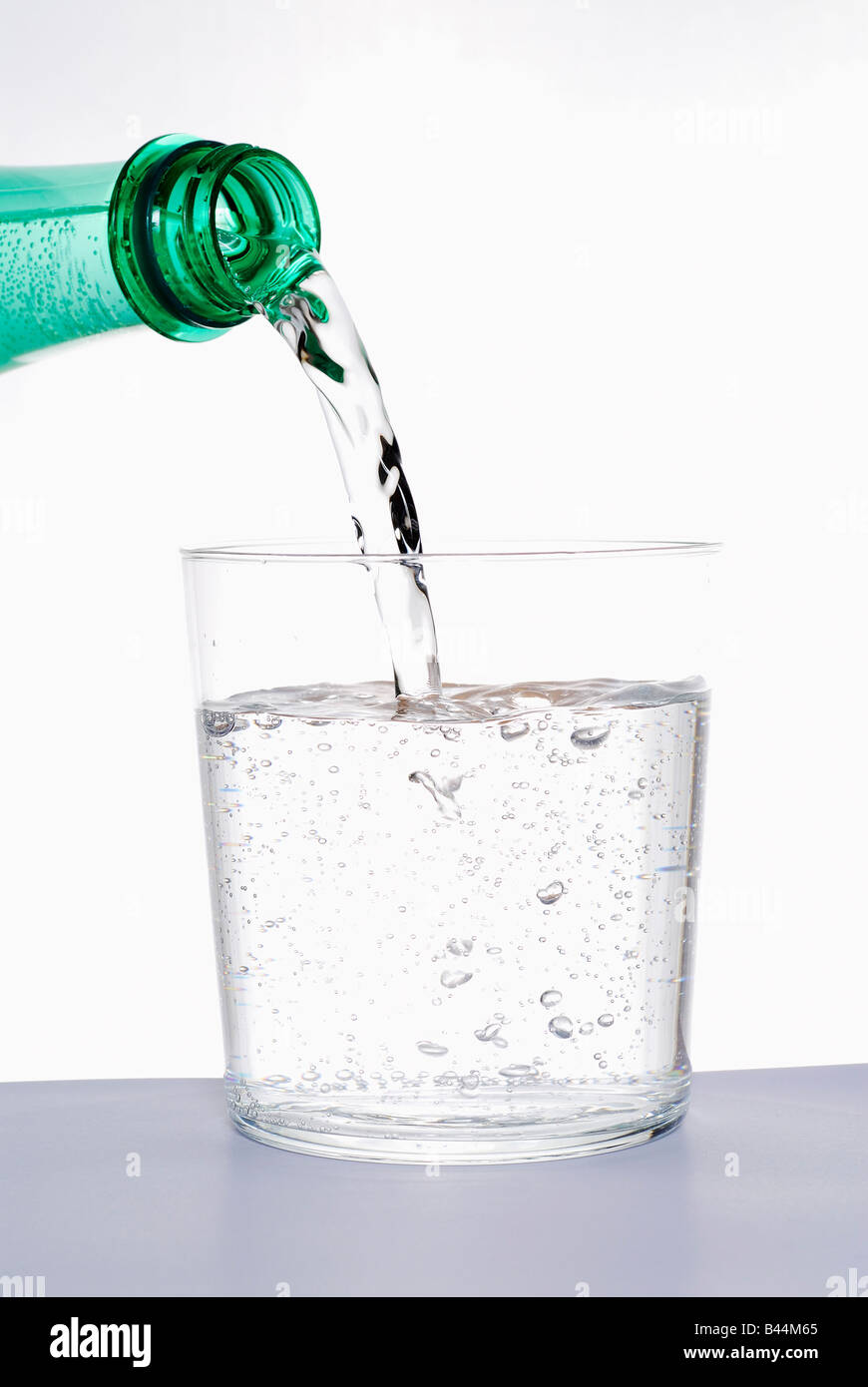 Pouring fizzy water into a glass Stock Photo - Alamy
