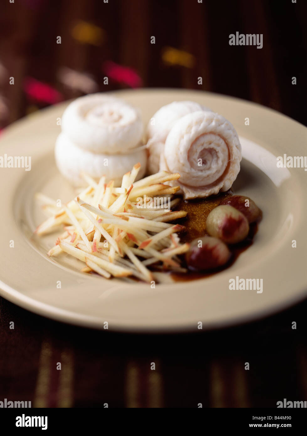 Rolled sole fillets with coffee sauce,apples and grapes Stock Photo - Alamy
