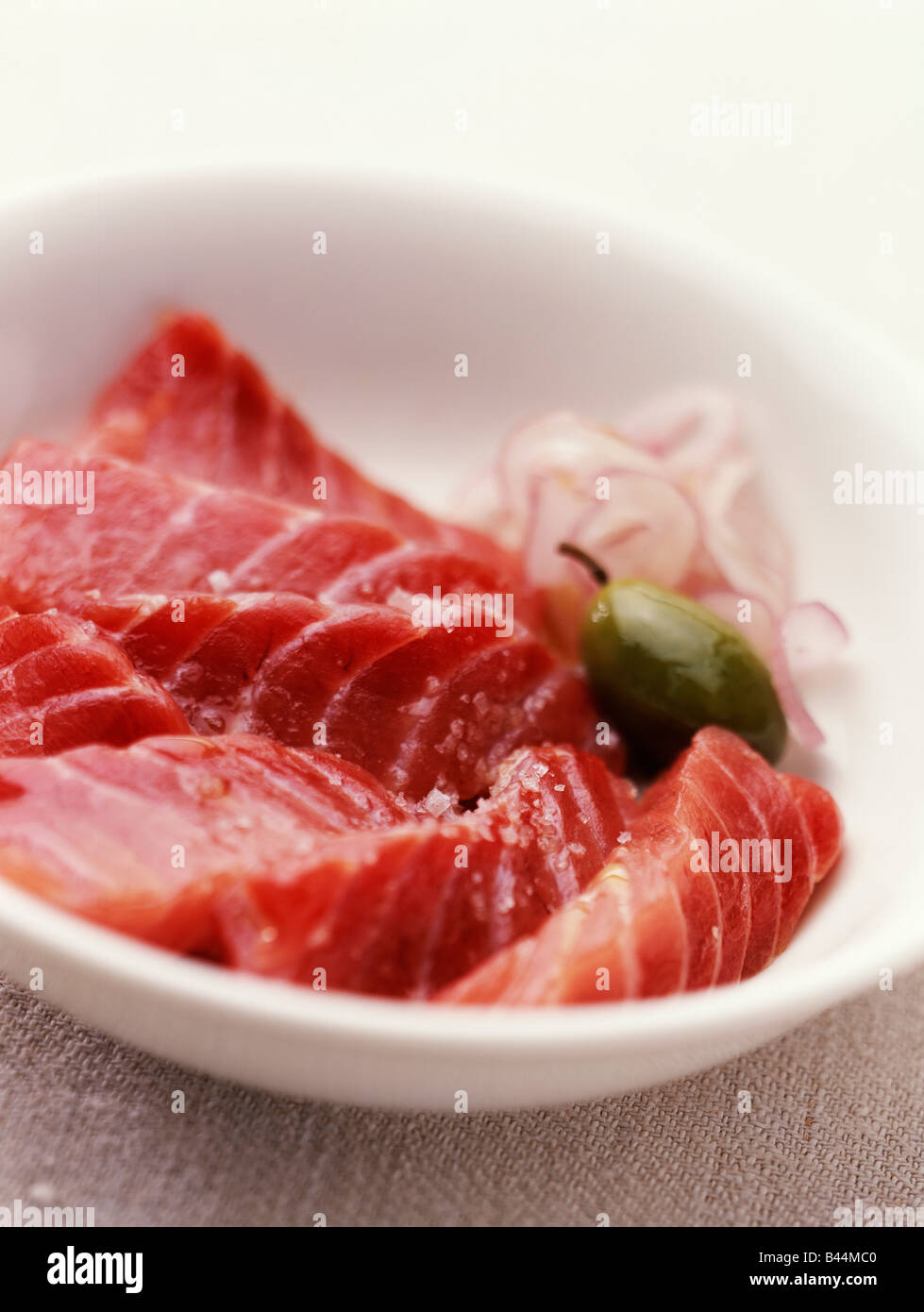 Pieces of raw marinated red tuna Stock Photo - Alamy