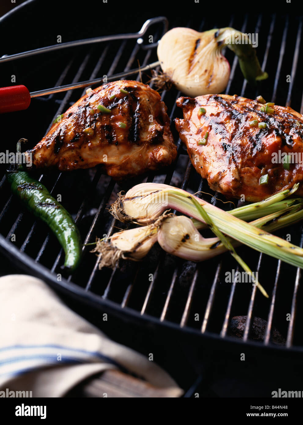 Chicken and spring onions on the barbecue Stock Photo - Alamy